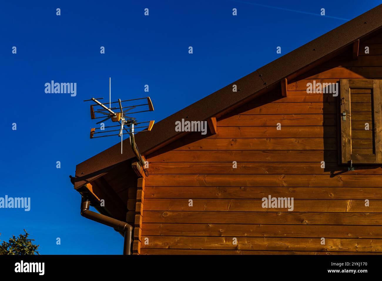 TV antenna on the wooden facade of the house Stock Photo - Alamy