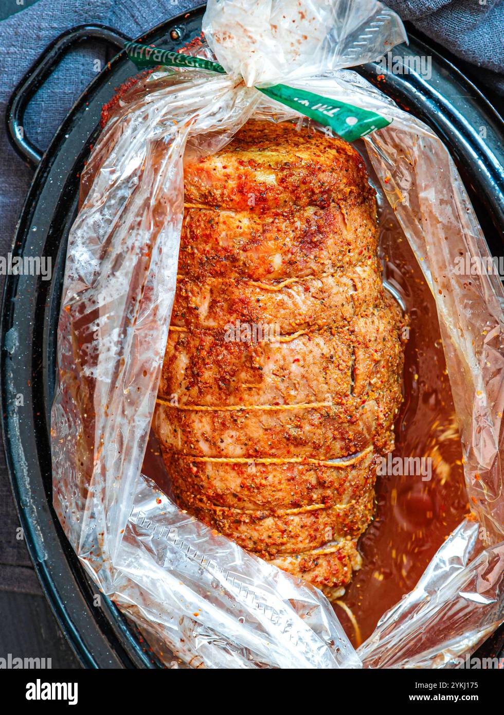 Baked a piece of pork meat in spices and wrapped with threads Stock ...