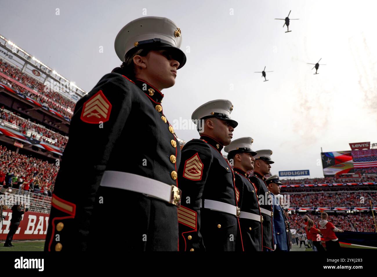 U.S. military personal stand during the National Anthem as a flyover ...