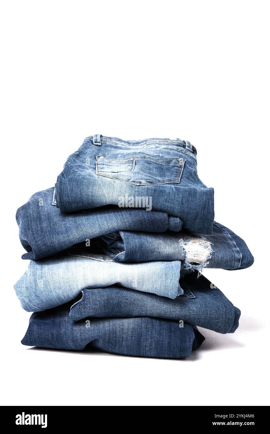 Stack of folded blue jeans on white background Stock Photo - Alamy
