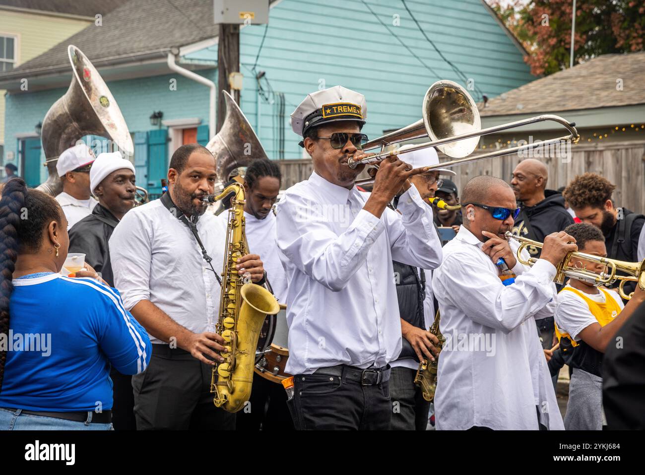 A Second Line parade moving through the streets of the Treme ...