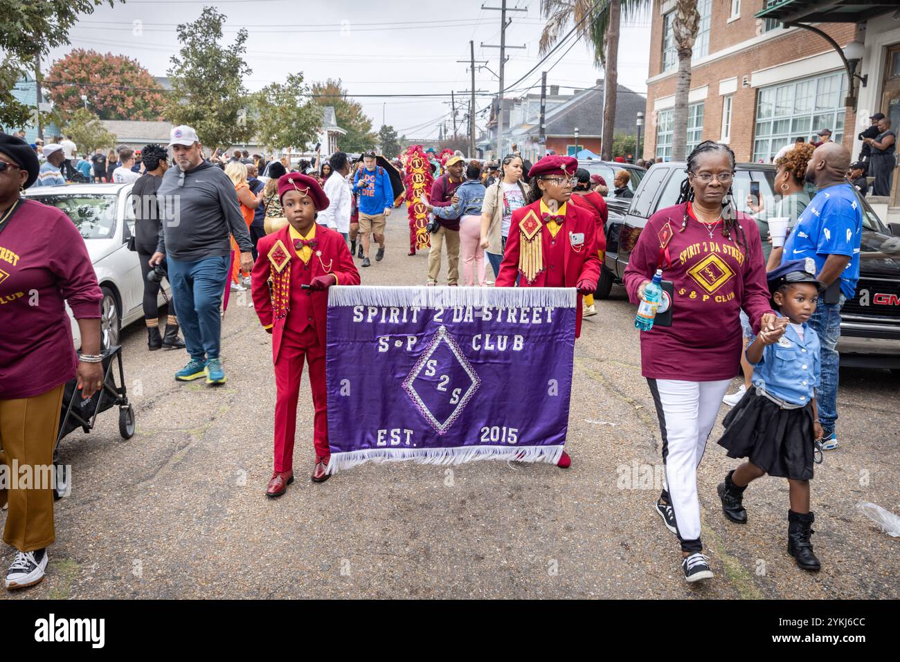 A Second Line parade moving through the streets of the Treme ...