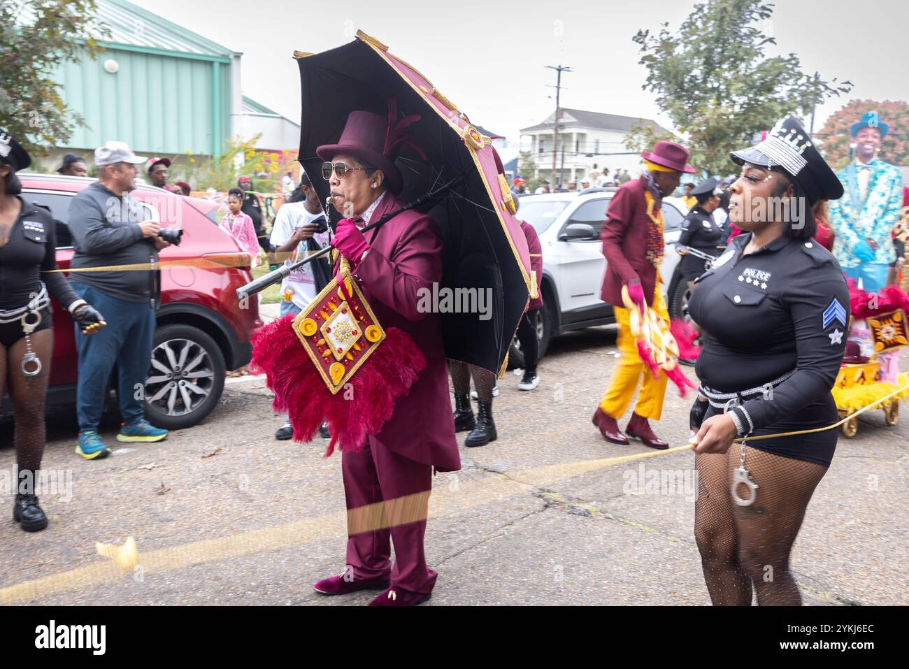 A Second Line parade moving through the streets of the Treme ...