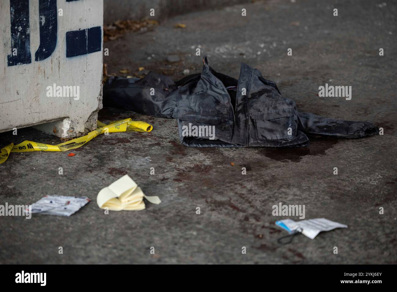 A jacket covered in blood lays on the ground at the site of a stabbing ...