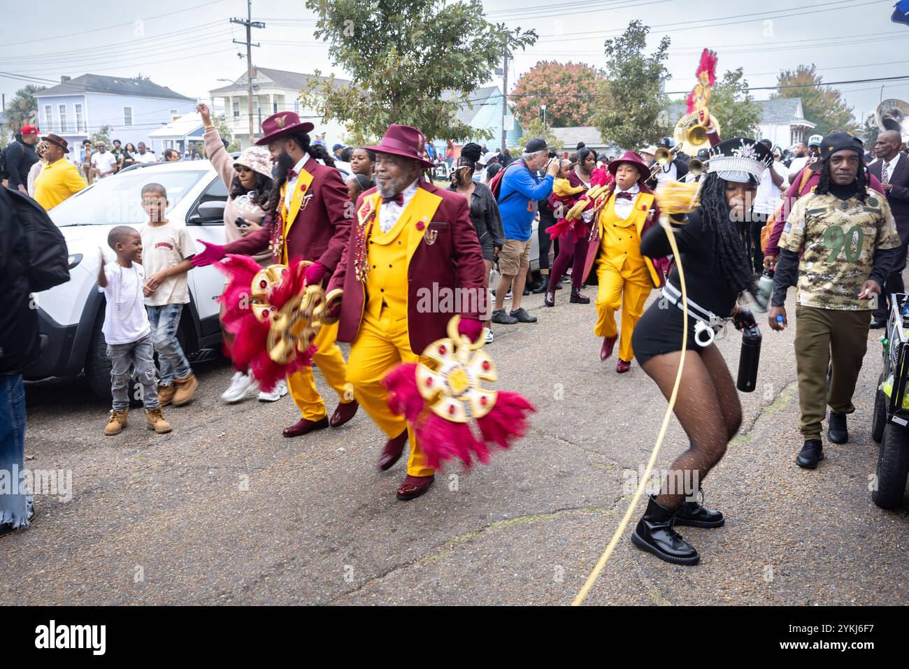 A Second Line parade moving through the streets of the Treme ...