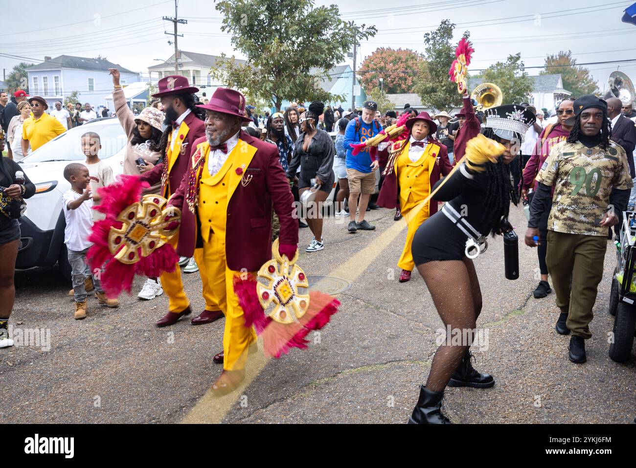A Second Line parade moving through the streets of the Treme ...