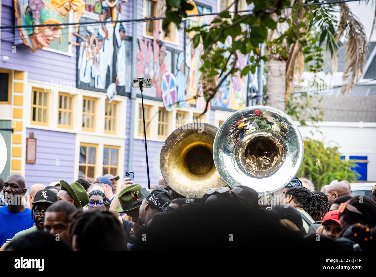 A Second Line parade moving through the streets of the Treme ...