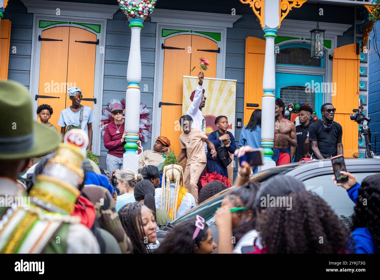 Spectators dancing and cheering the Second Line parade moving through ...