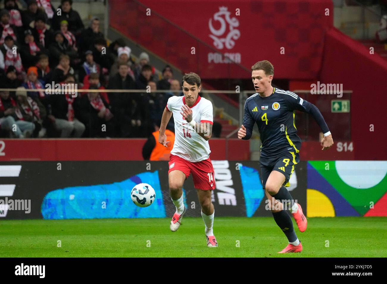 Scotland's Scott McTominay, right, controls the ball by Poland's Jakub ...