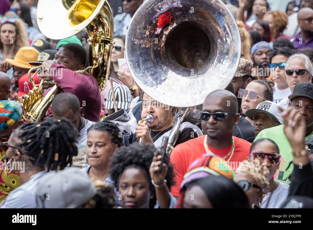A Second Line parade moving through the streets of the Treme ...
