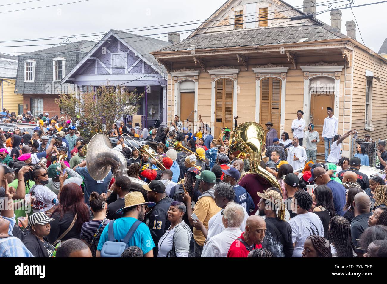 A Second Line parade moving through the streets of the Treme ...