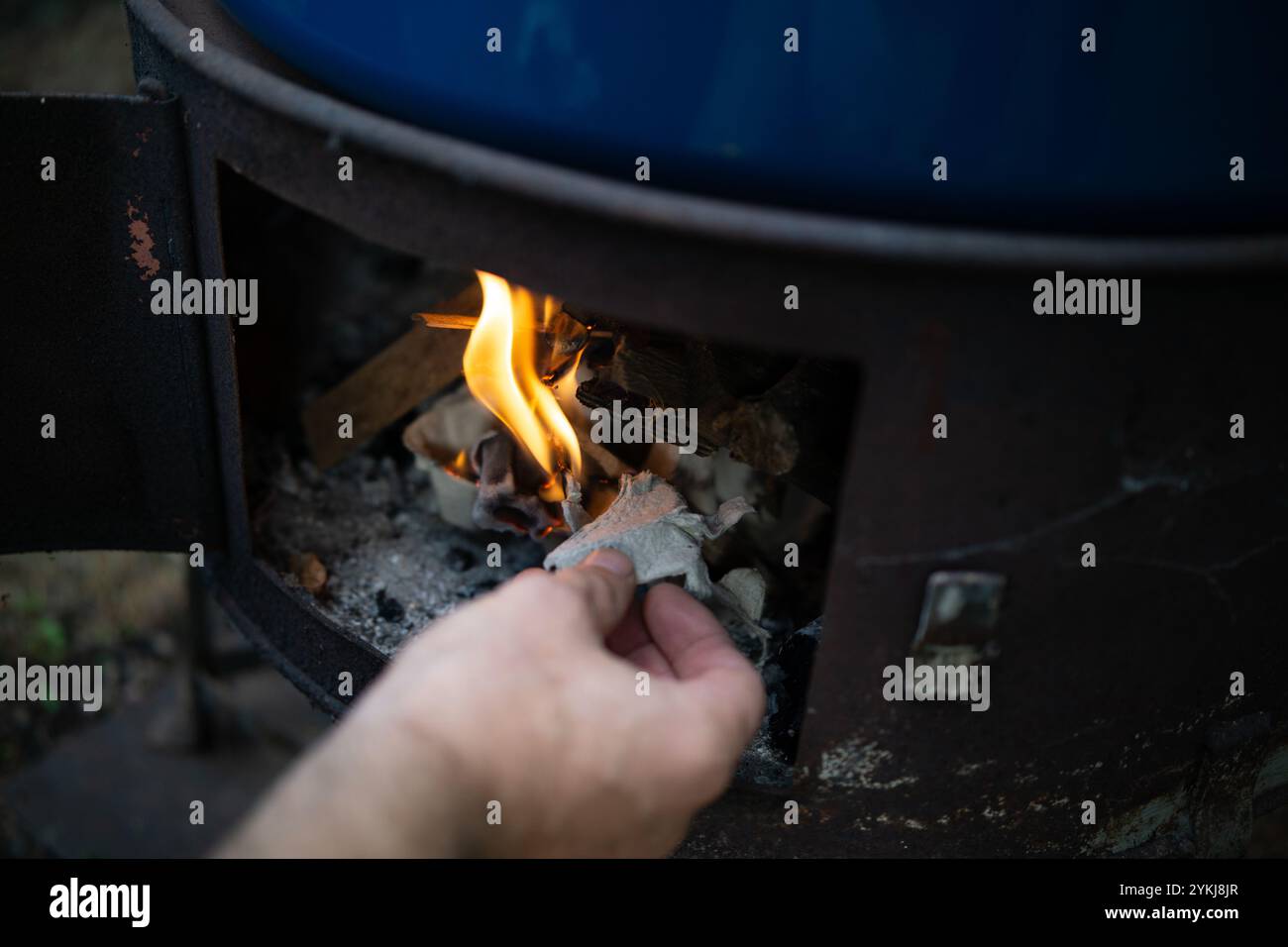 male hands starting fire in a fire pit Stock Photo - Alamy