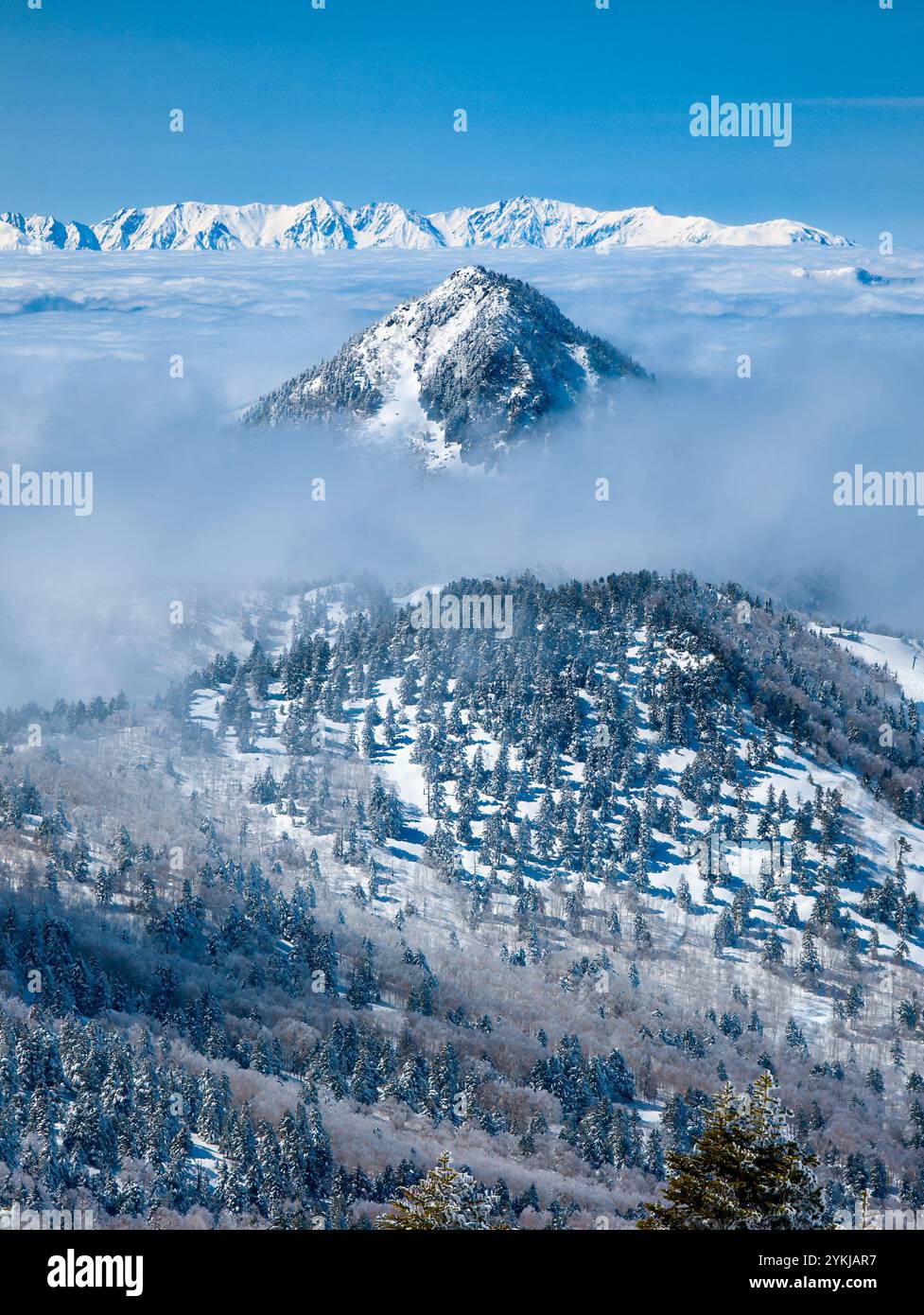 Snowy mountains and forests shrouded in a layer of cloud (Yokoteyama ...