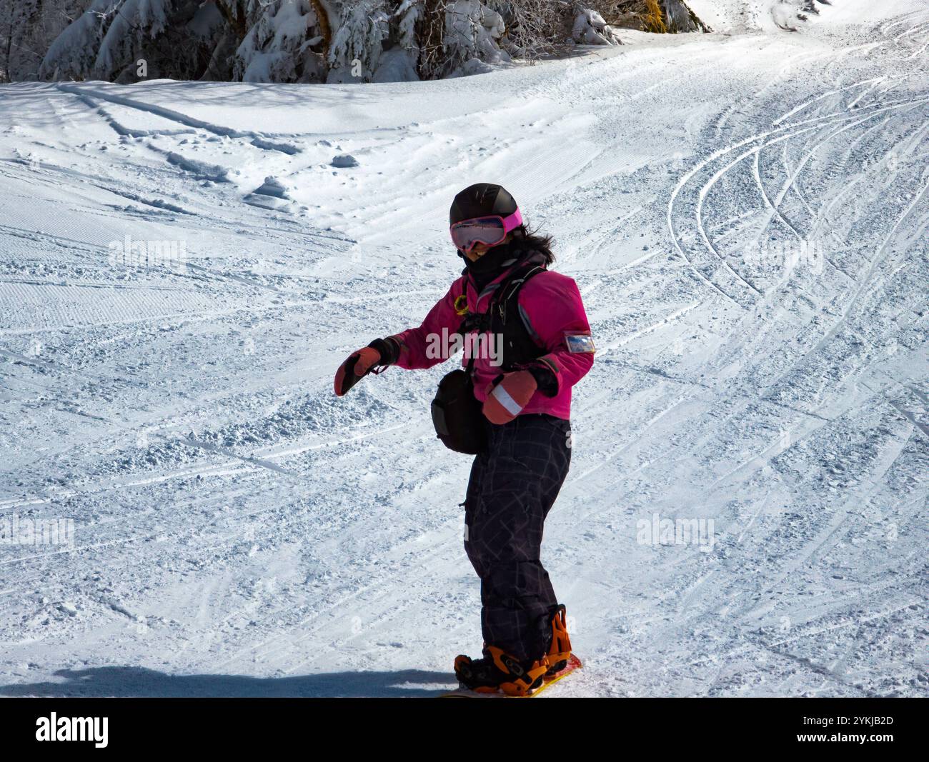 Female snowboarder on a groomed piste at Shibutoge ski area in Nagano ...
