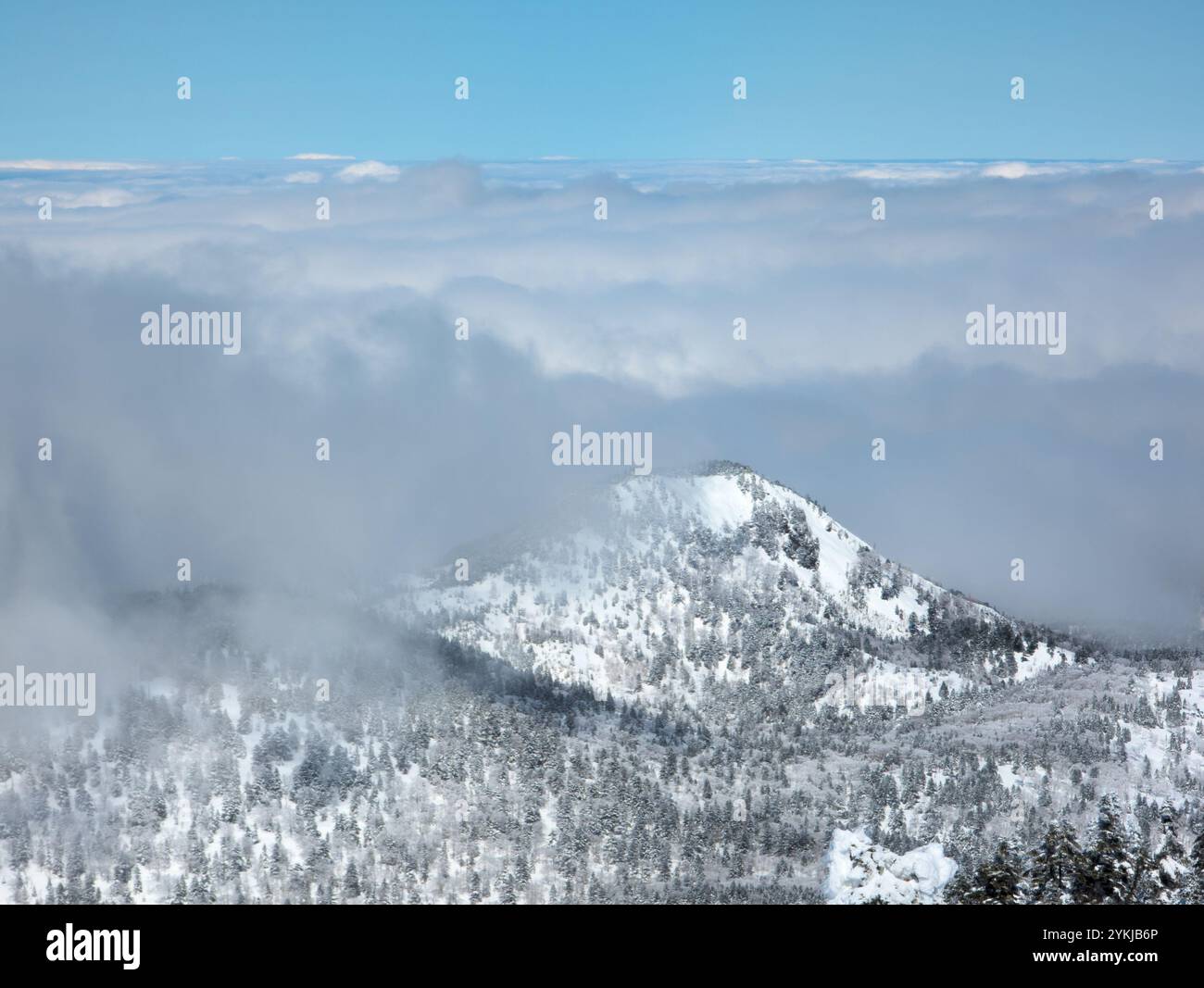 Snowy mountains and forests shrouded in a layer of cloud (Yokoteyama ...