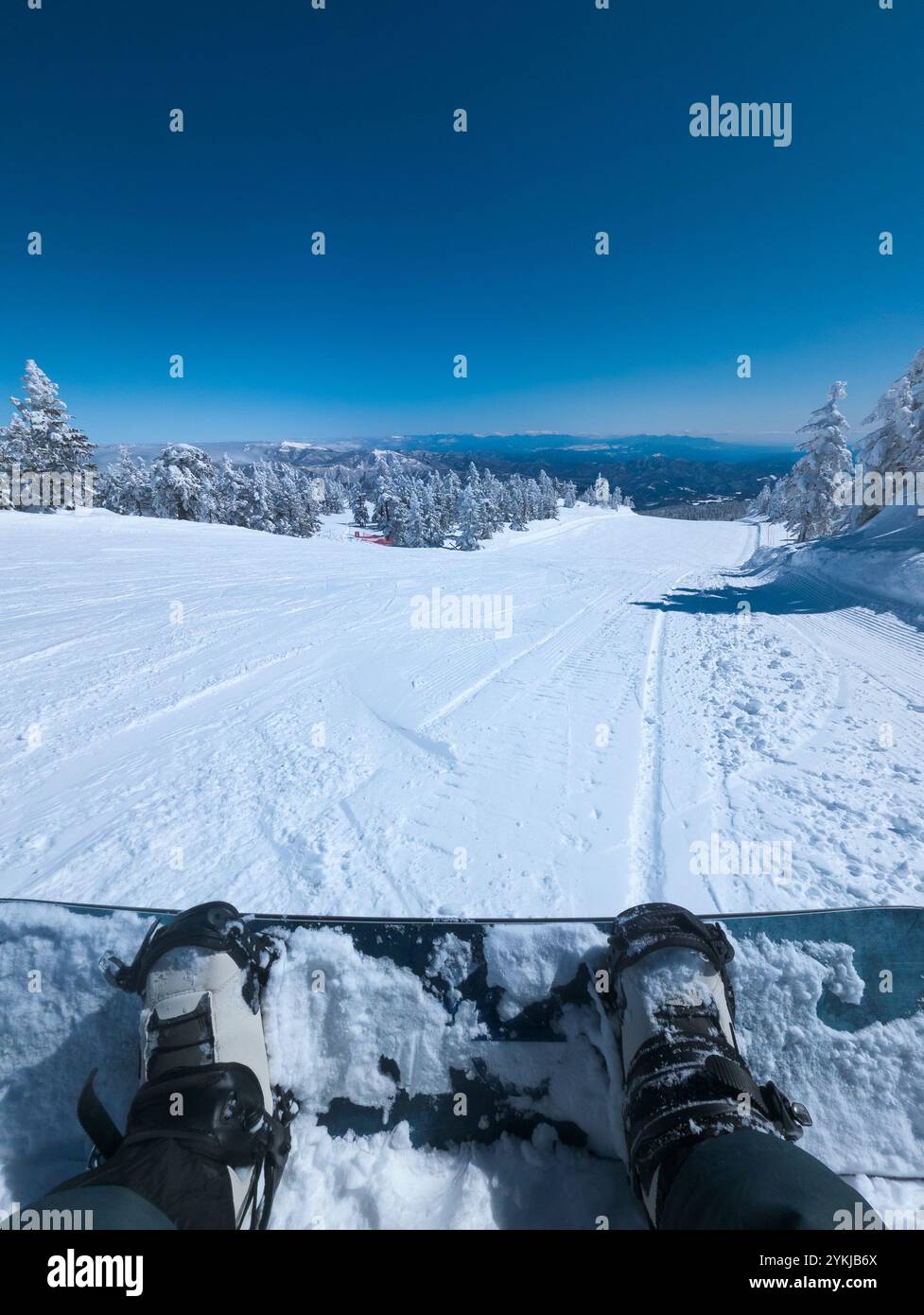 First person view of a snowboard at the top of a ski slope Stock Photo ...