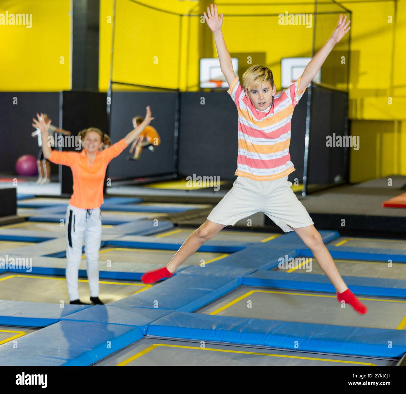 Preteen boy having while jumping in indoor trampoline arena Stock Photo ...