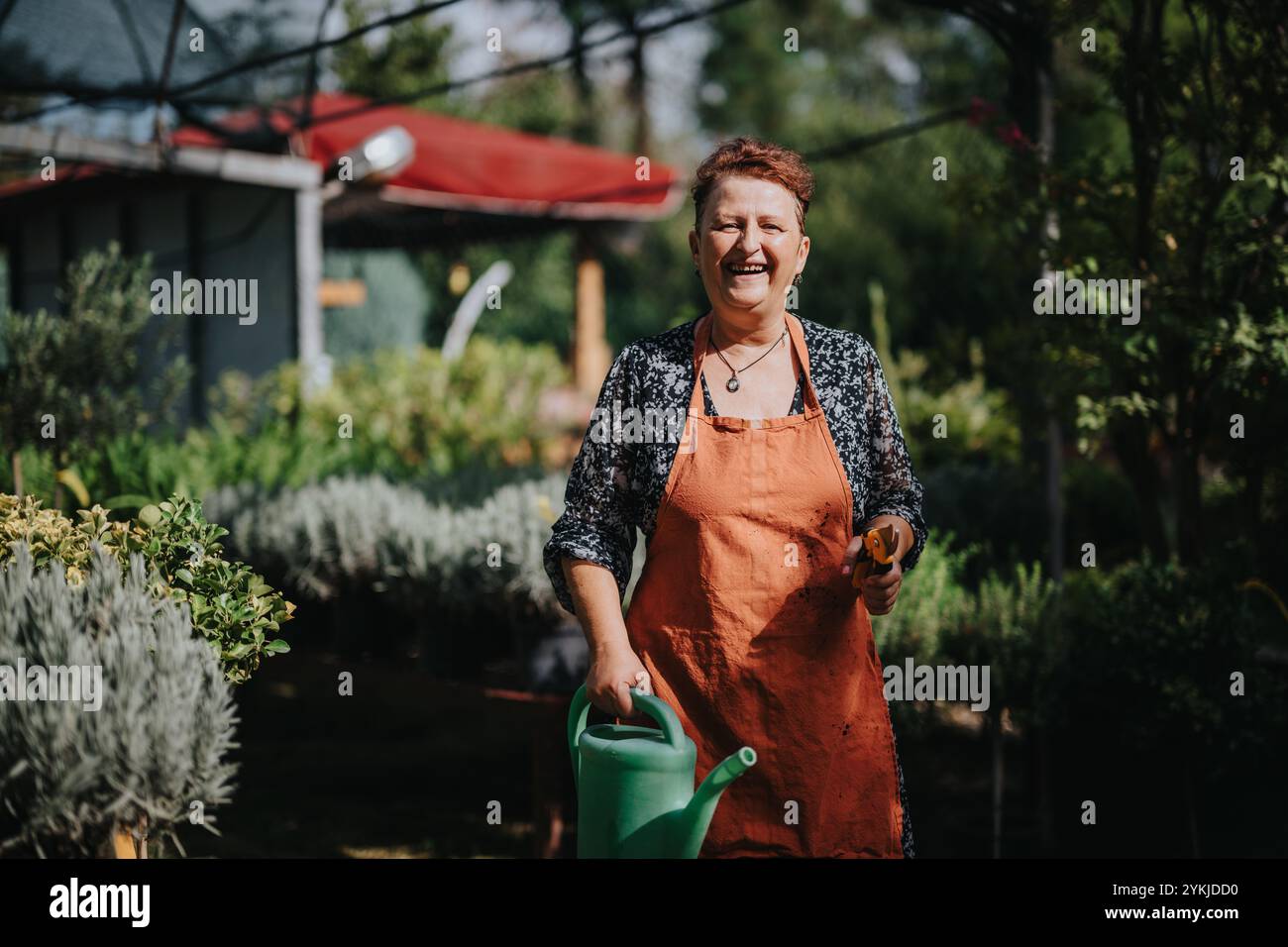 Woman smiling happily gardening hi-res stock photography and images - Alamy