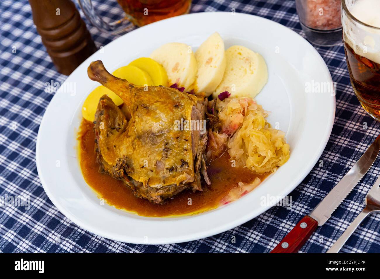 Grilled duck leg quarter with red and white cabbage Stock Photo - Alamy