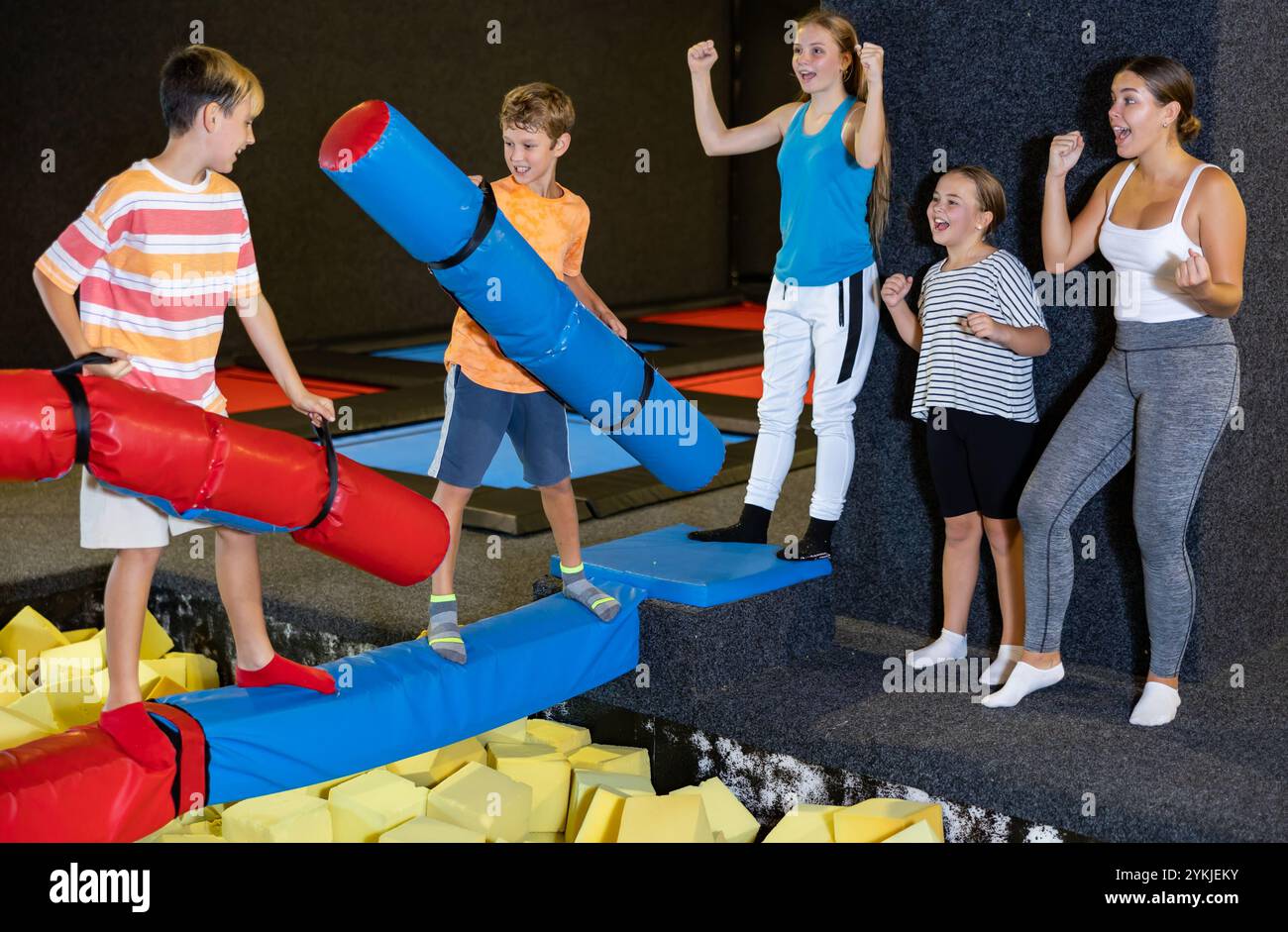 Active excited childschool boys fighting with inflatable logs in game ...
