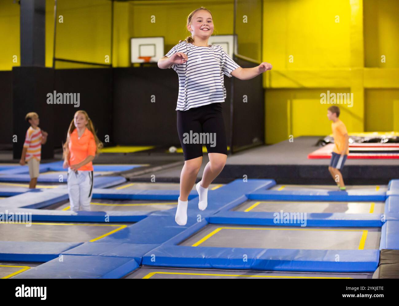 Tween girl having fun jumping in indoor trampoline arena Stock Photo - Alamy