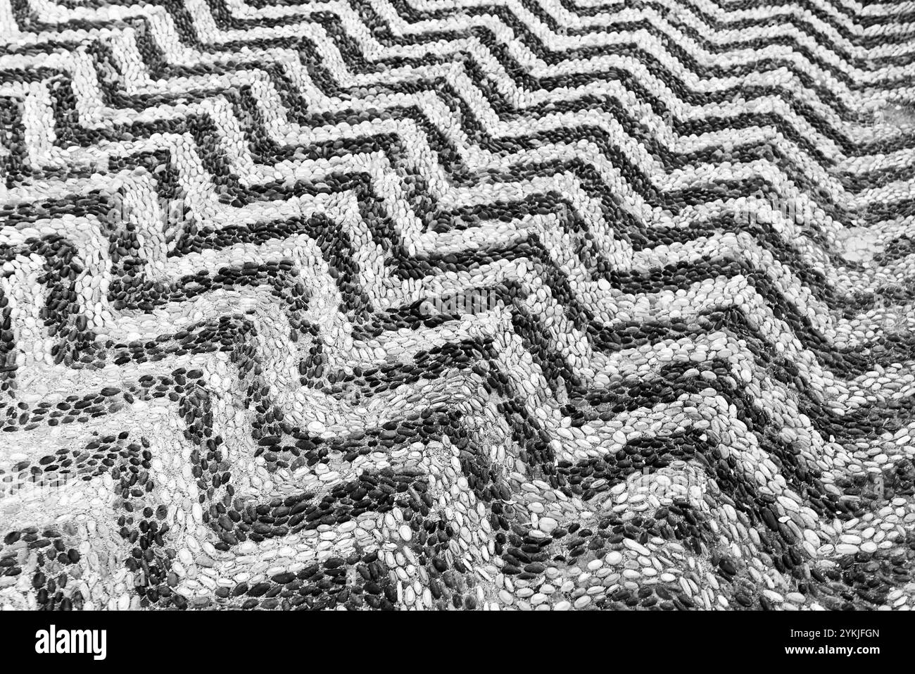 Mosaic pavement with striped pattern of black and white pebble stones ...