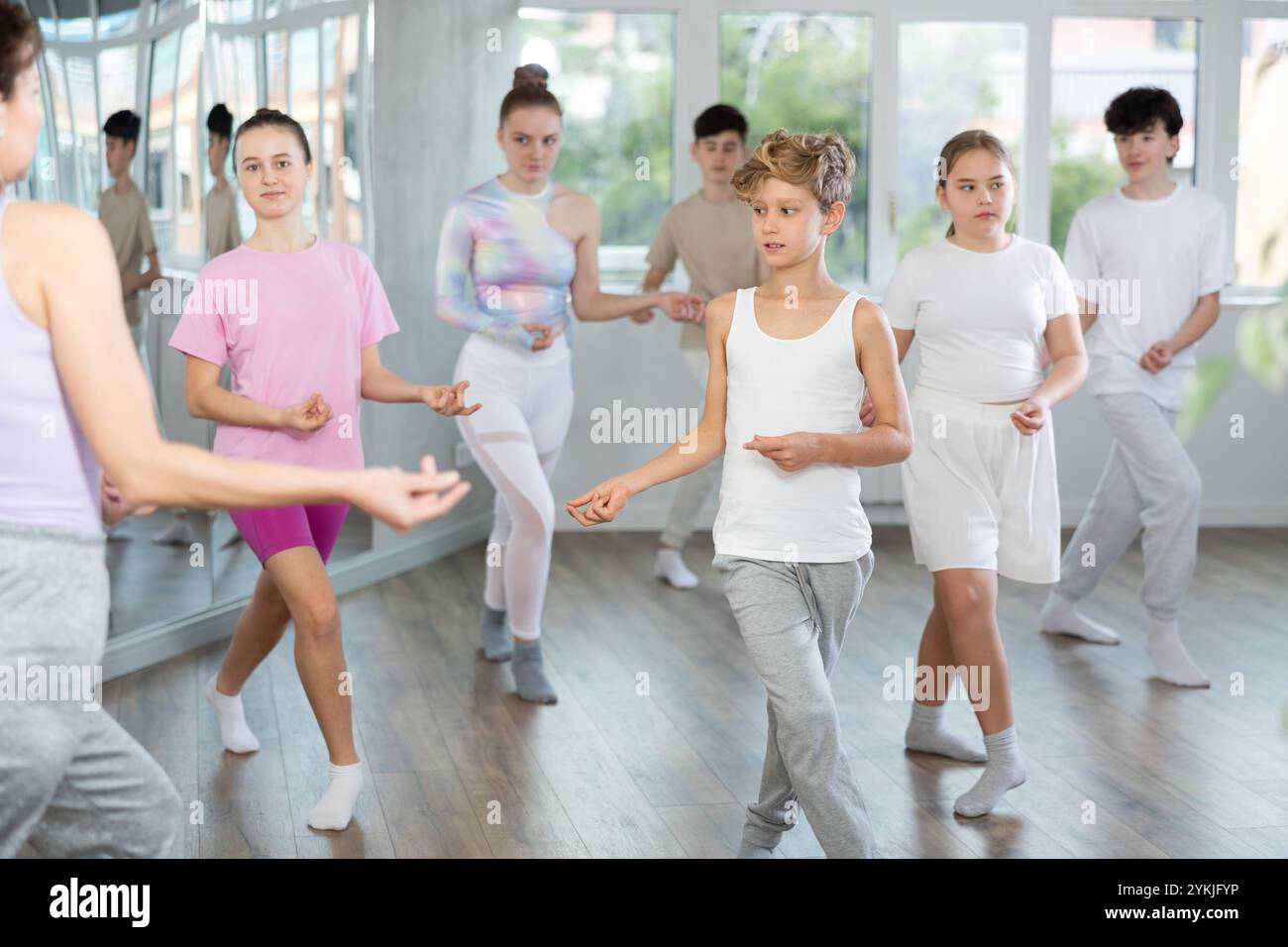 Male boy student repeats movements of unrecognizable teacher during ...