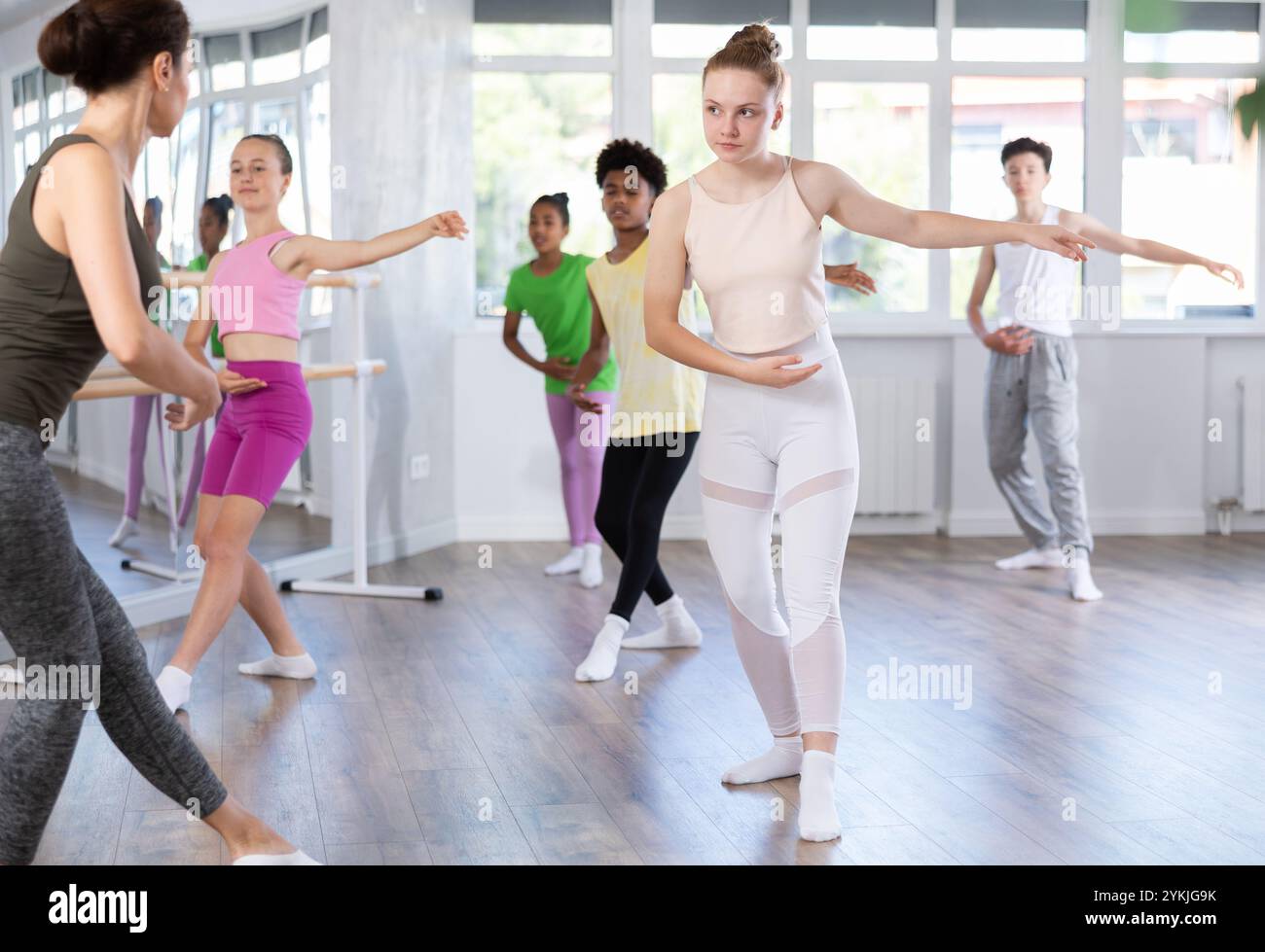 Teen girl practicing ballet movements at group class Stock Photo - Alamy