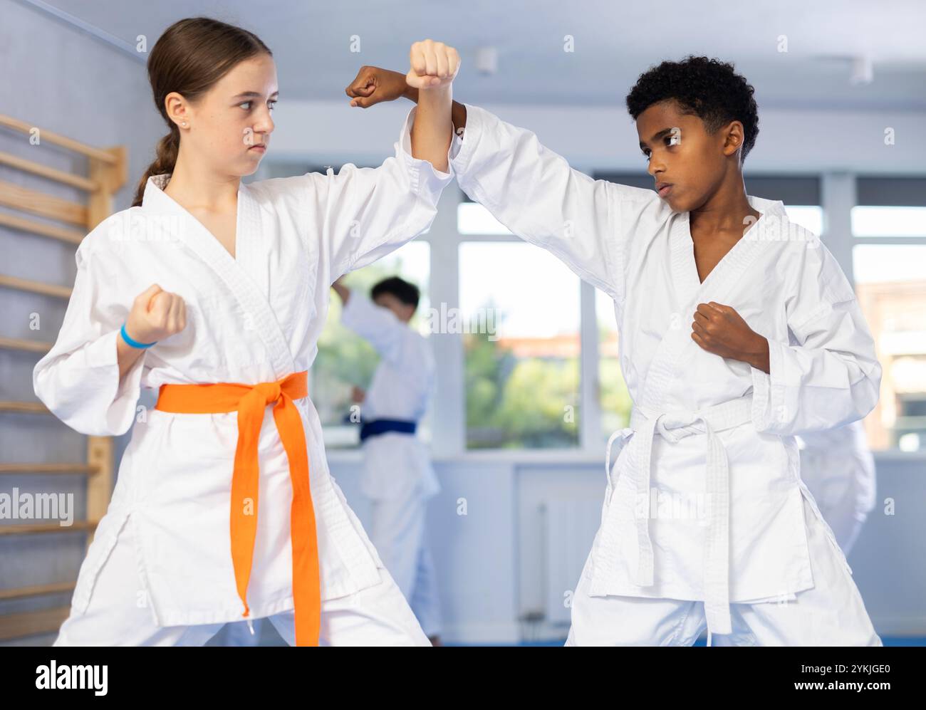 Karate training - girl and boy of different nationalities in pairs ...