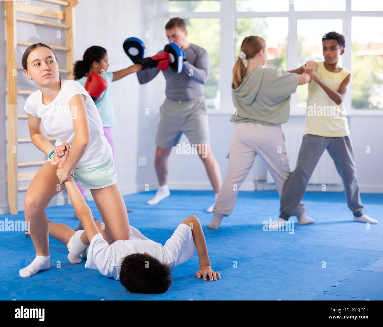 Self-defense - girl twists the arm of an attacking boy during self ...