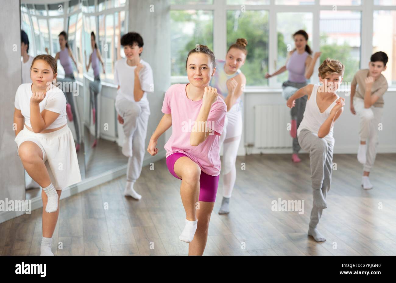 Team of teenagers rehearsing modern dances in dance hall Stock Photo ...