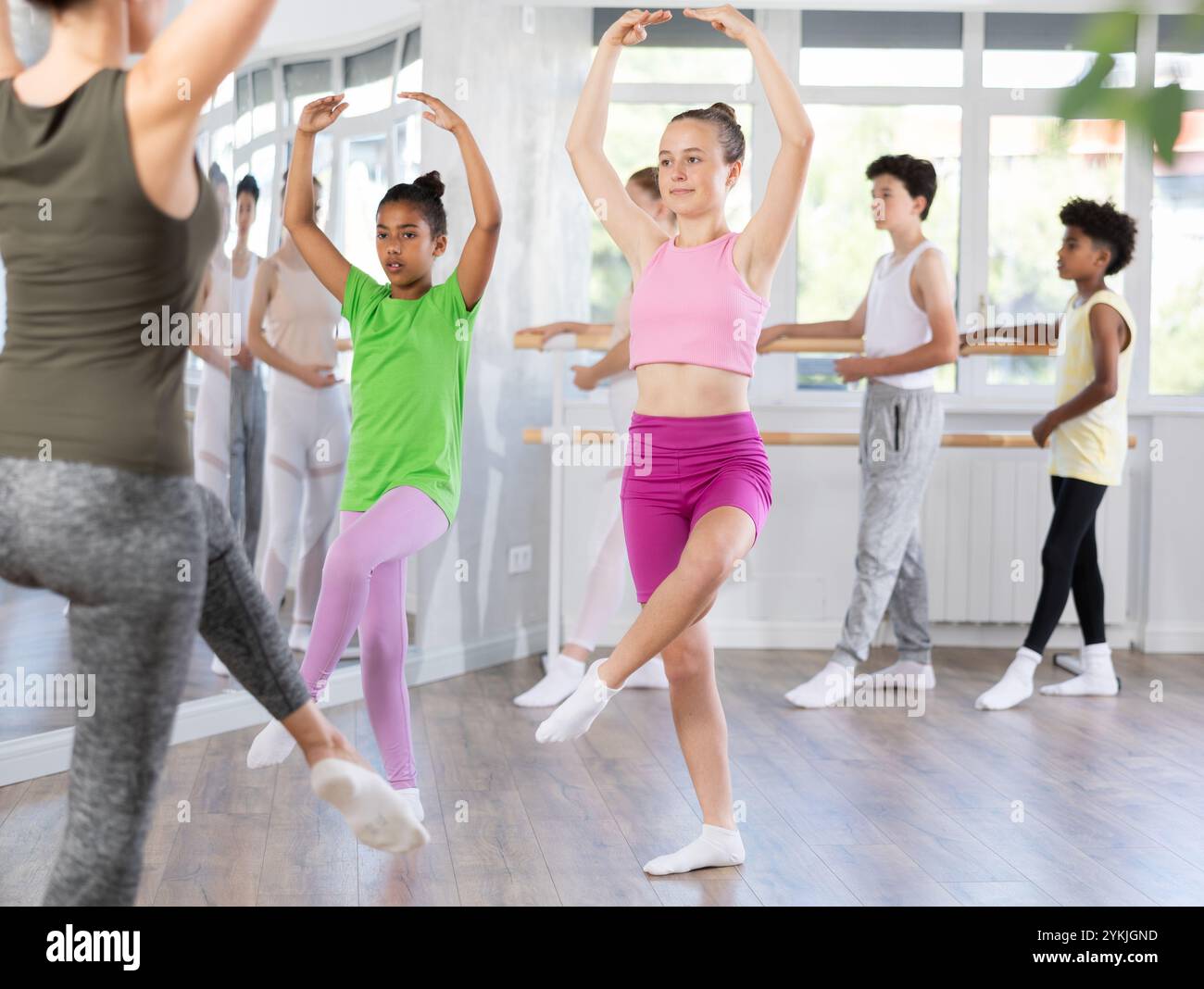 Teen girl practicing ballet movements at group class Stock Photo - Alamy