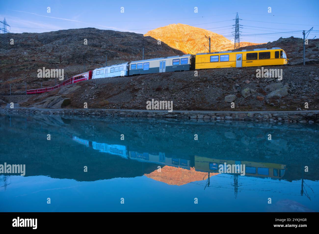 Bernina express train and alpine lake with colorful reflections Stock ...