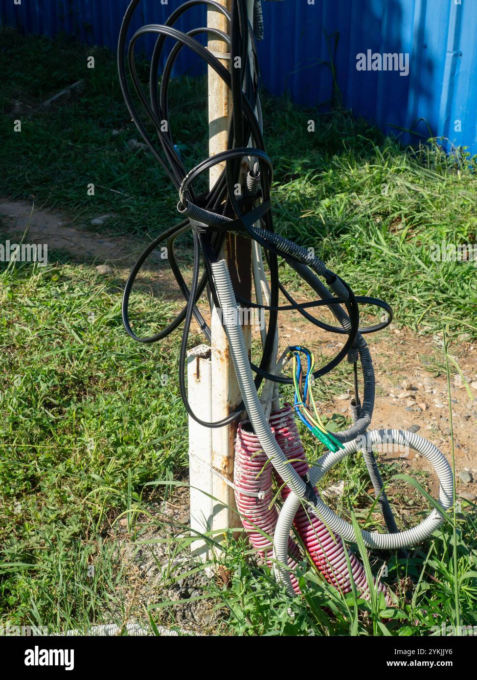 Exposed wiring in a metal pole. Wires sticking out. Pole with wires. Disadvantages. Dangerous ...