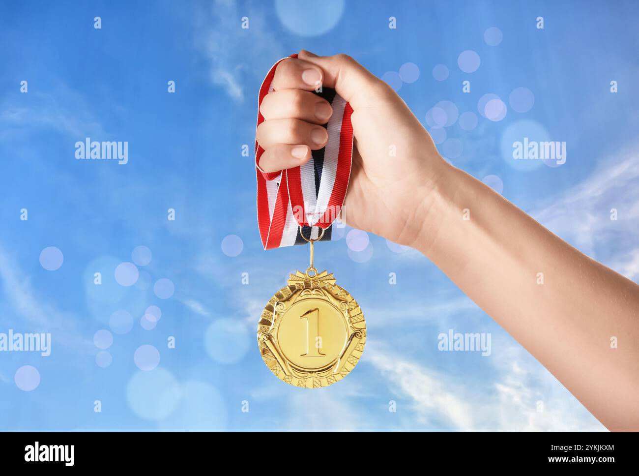 Hand holding golden medal hi-res stock photography and images - Alamy
