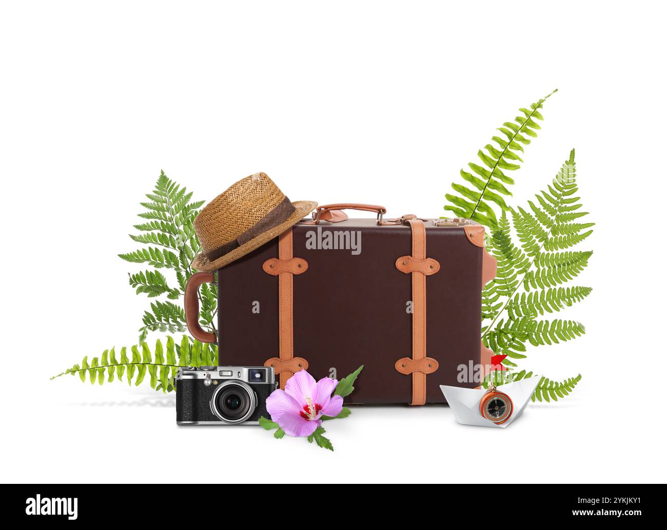 Leather travel suitcase, paper boat with compass, hat, camera, tropical ...