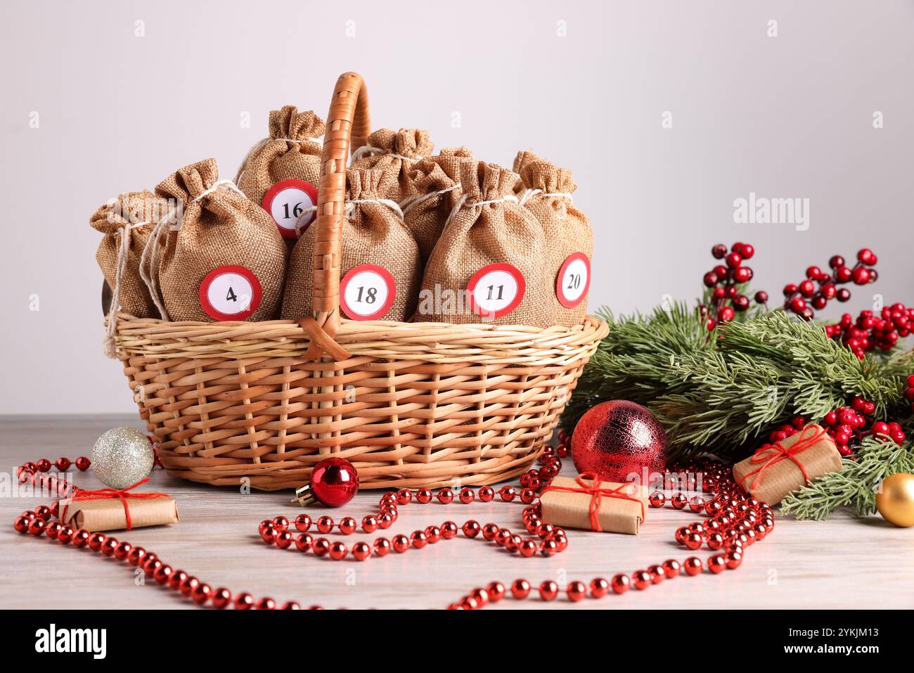 Christmas advent calendar with gifts in wicker basket and decor on ...