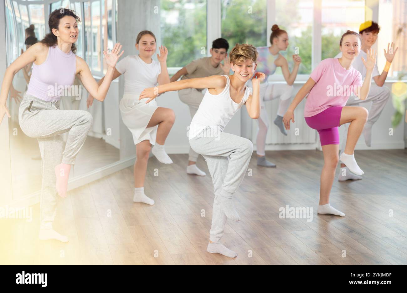 Group of teenagers, girls and boys dance modern dance together with ...