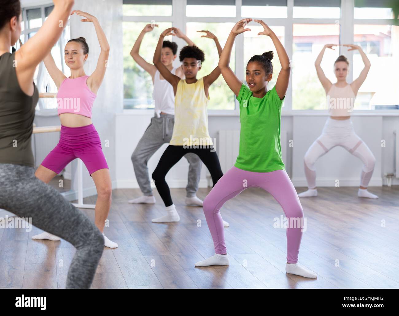 African american teen girl participating in beginner group ballet class ...
