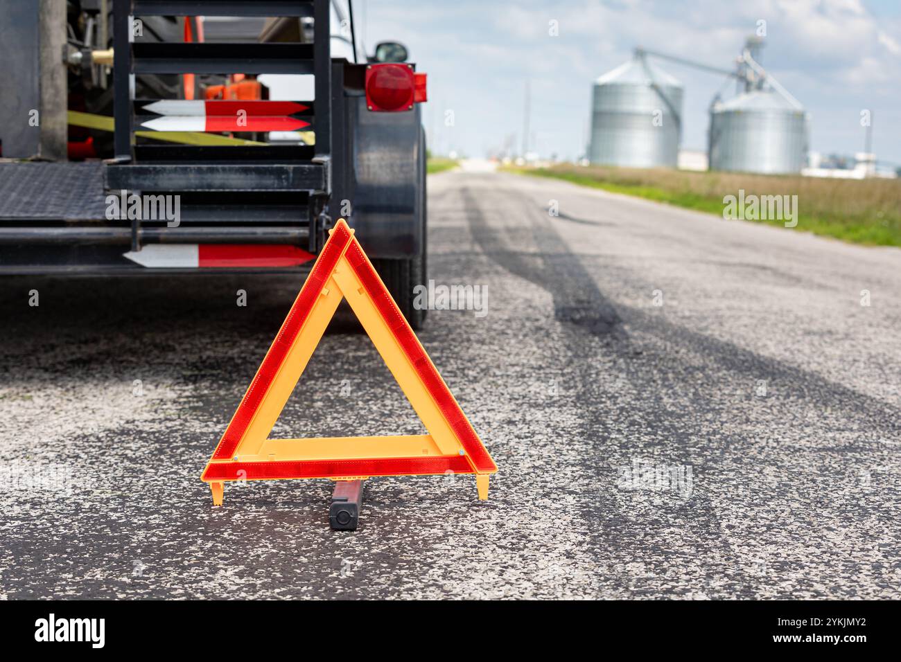 Work trailer on side of road with warning triangle. Emergency roadside ...