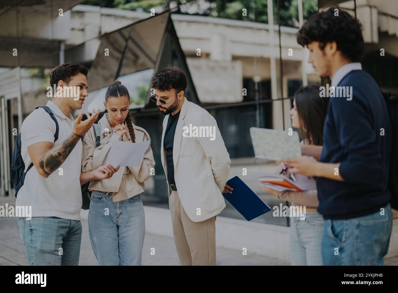 Group of students discussing project with professor outdoors Stock ...