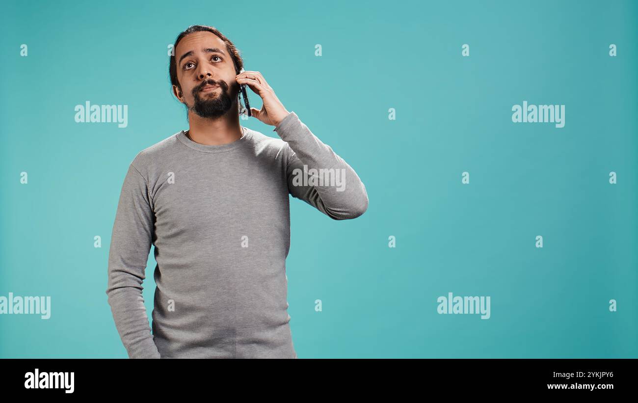 Man discussing with best friend over telephone call using smartphone ...