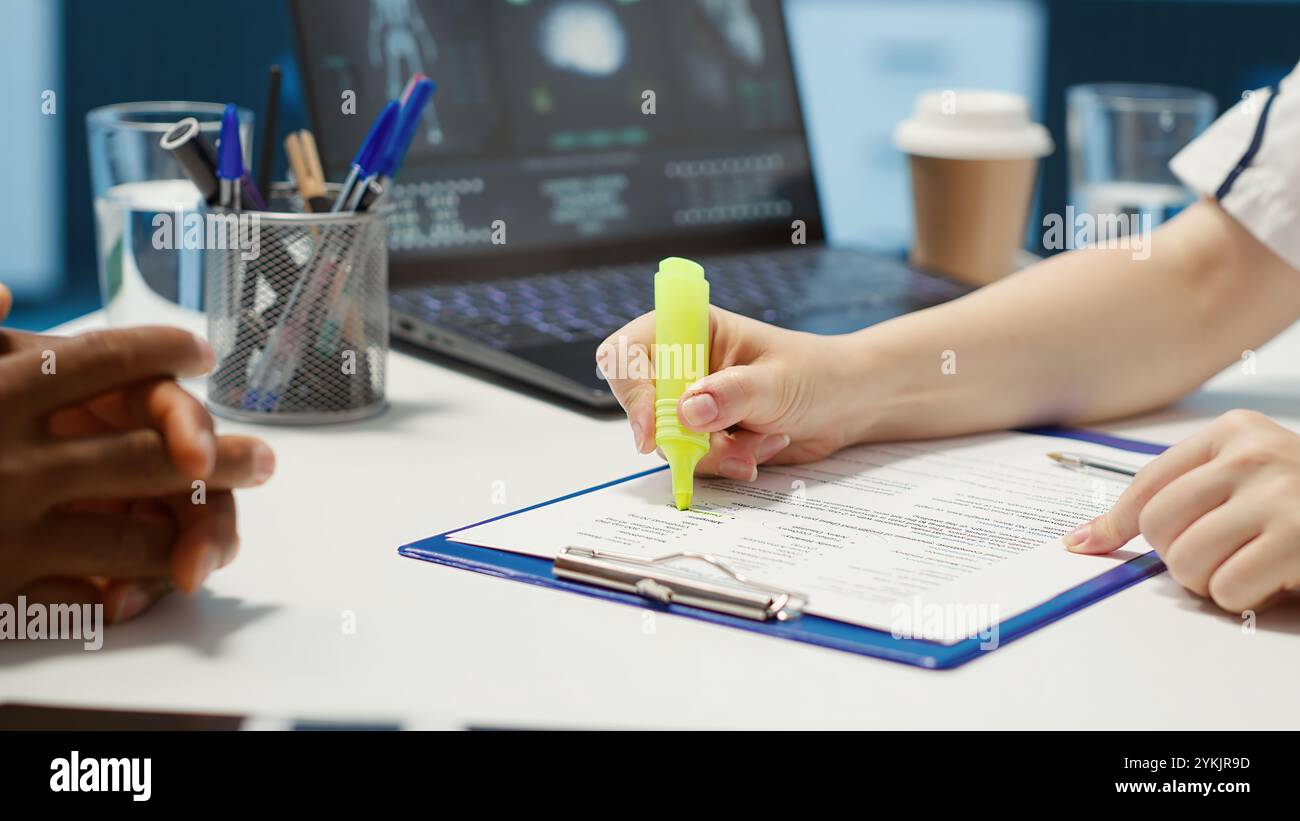 Female doctor highlighting the medical instructions and dosage on a ...