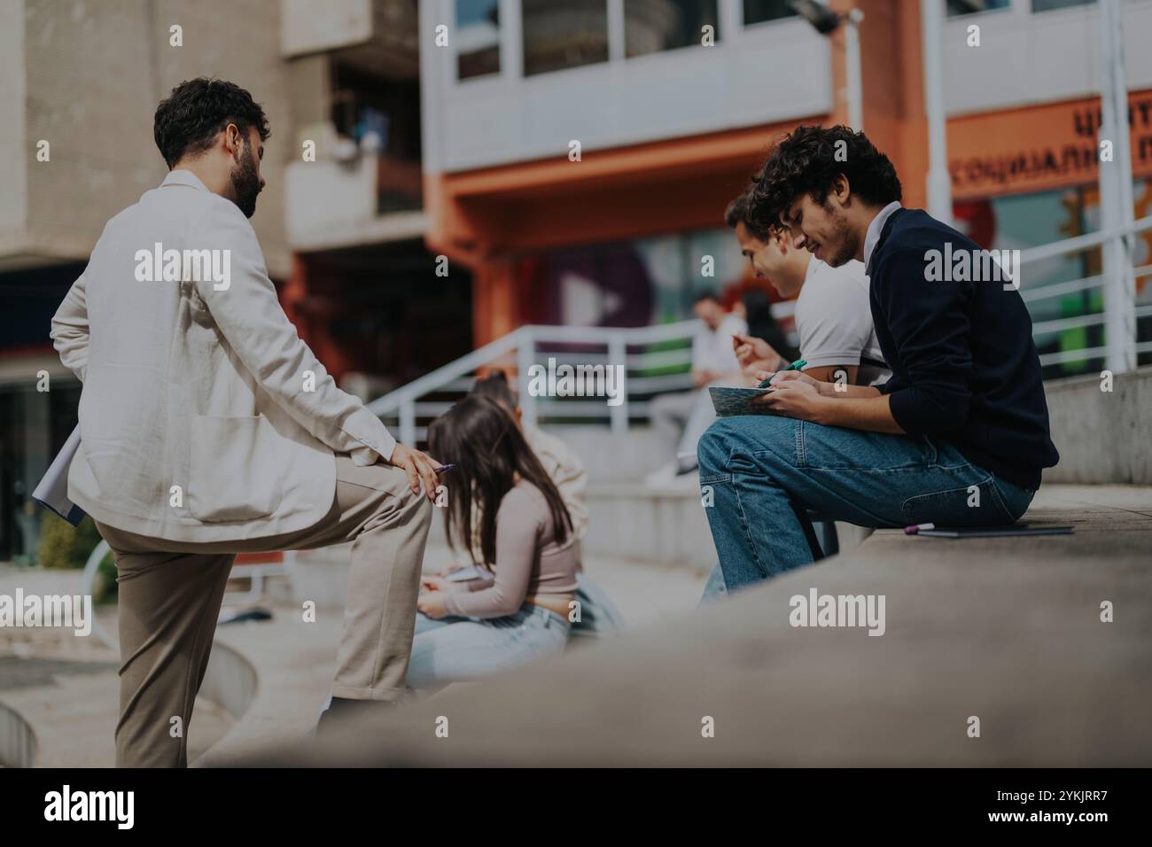 Group of students outdoor collaborating with engaged professor Stock ...