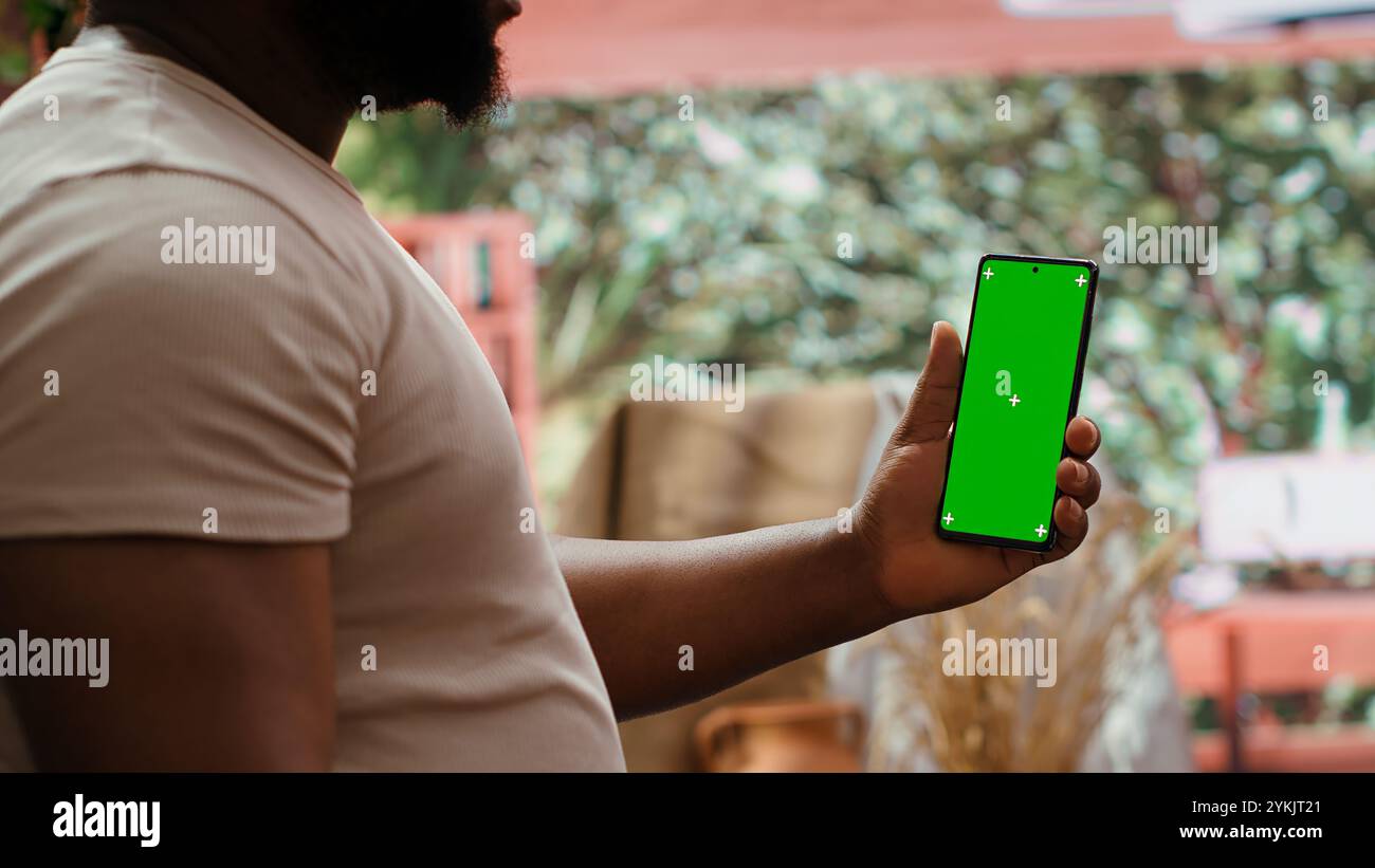 African american artist holding device with green screen mockup in art ...