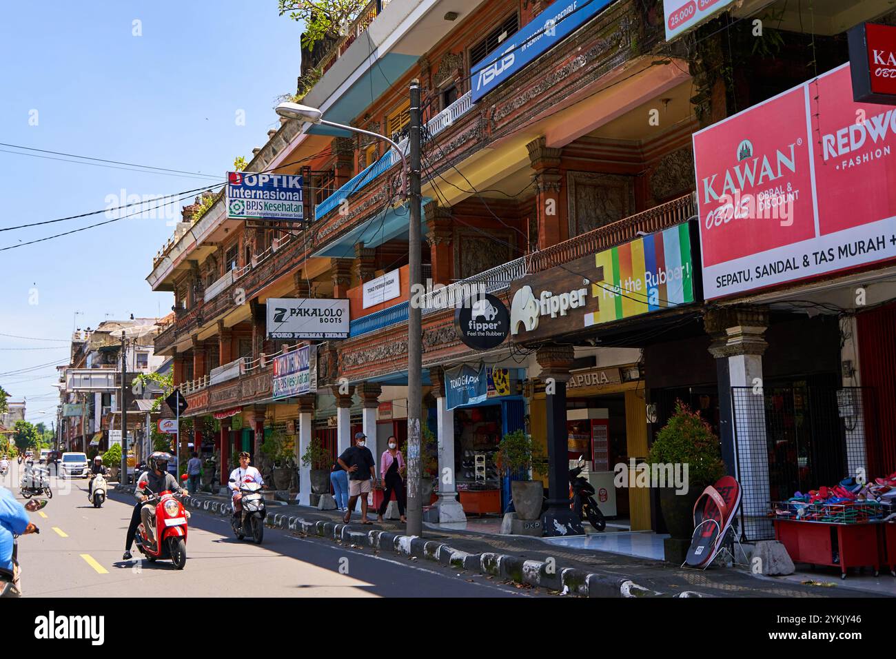 An old weathered building is covered with billboards in an Asian city ...