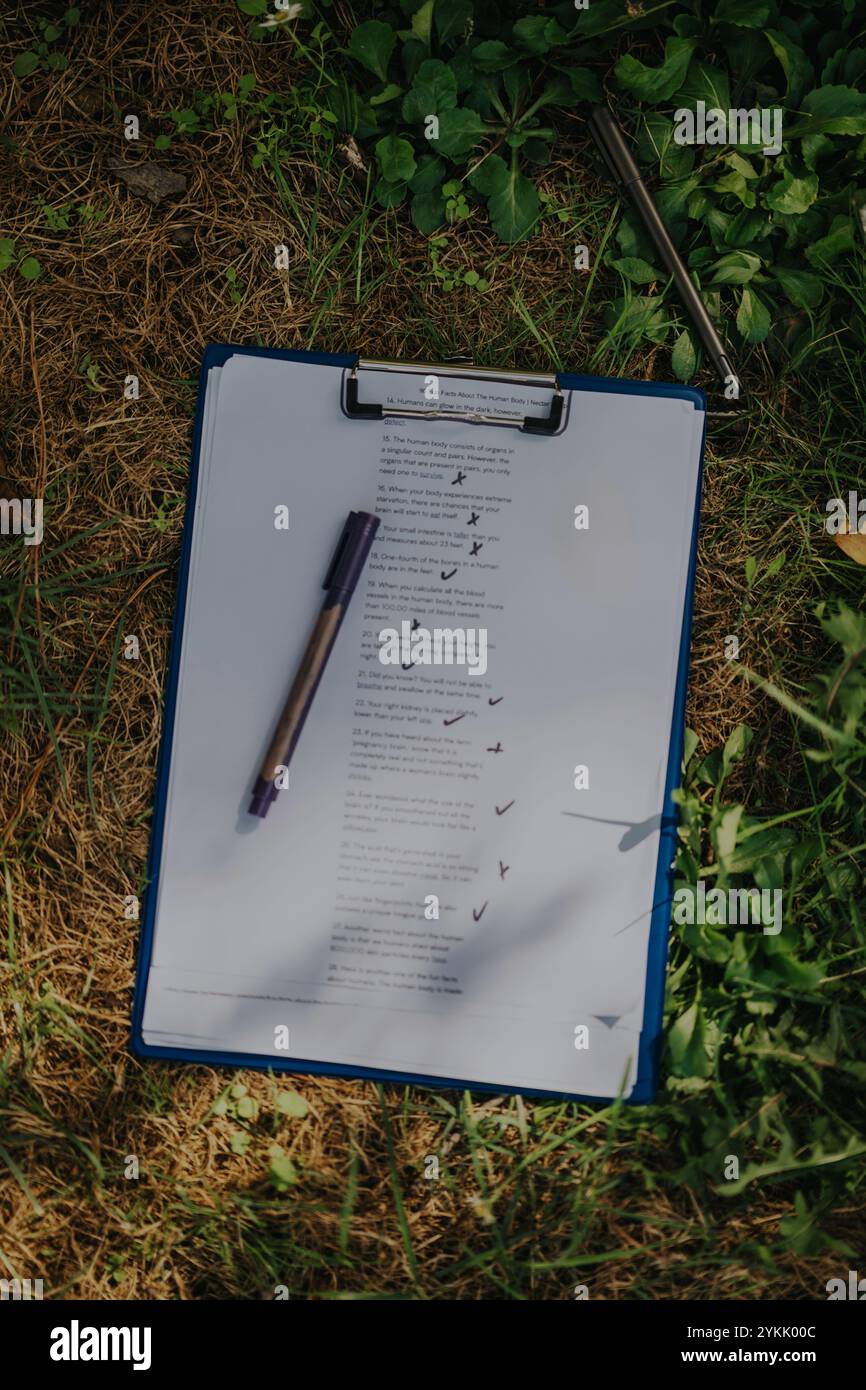 Checklist with pen on clipboard outdoors in natural setting Stock Photo ...