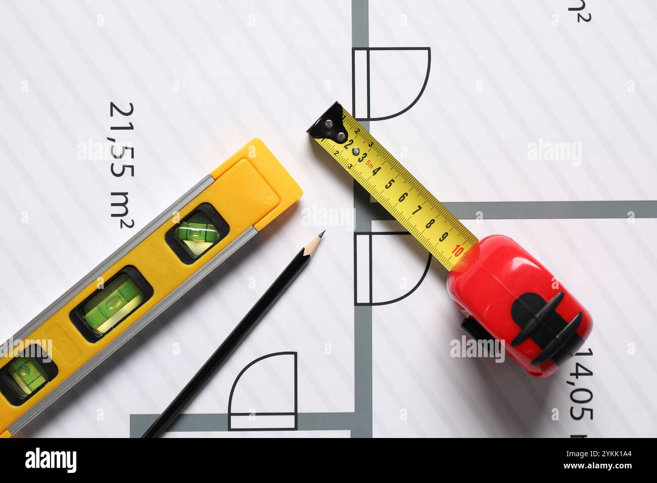 Pencil, measuring tape and building level on different architectural ...