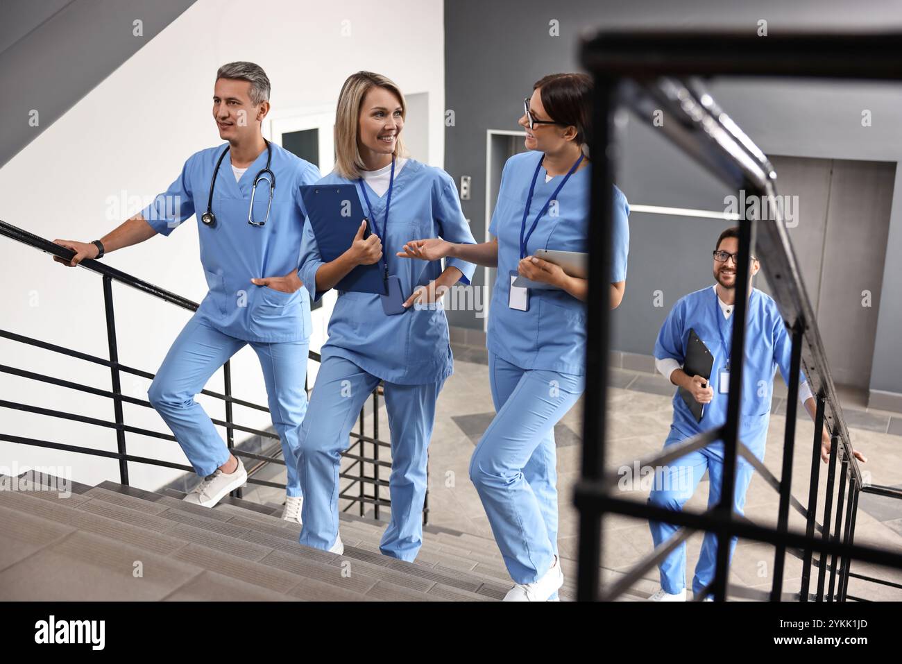 Healthcare workers walking up stairs in hospital Stock Photo - Alamy