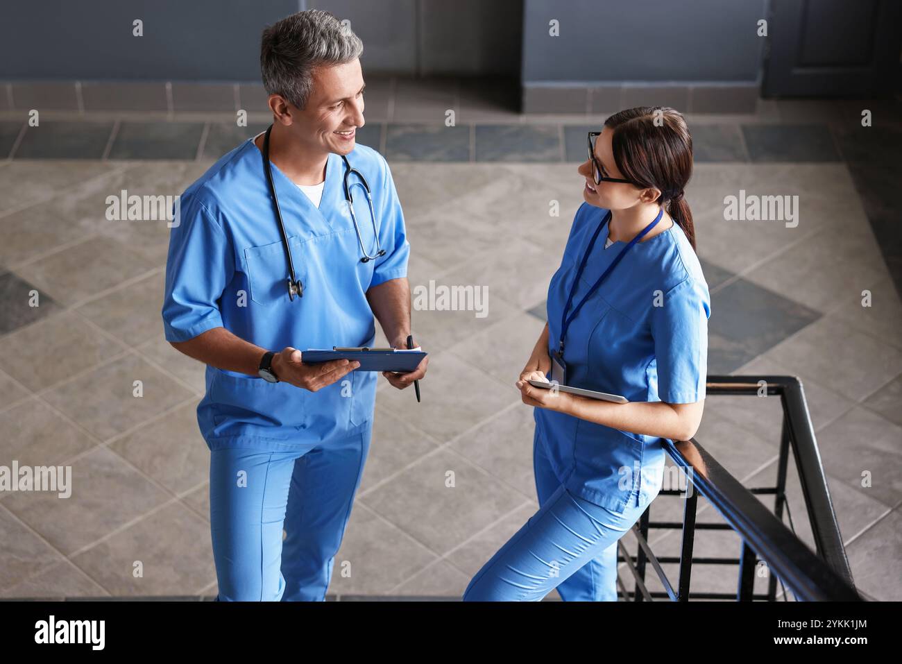 Healthcare workers talking on stairs in hospital Stock Photo - Alamy